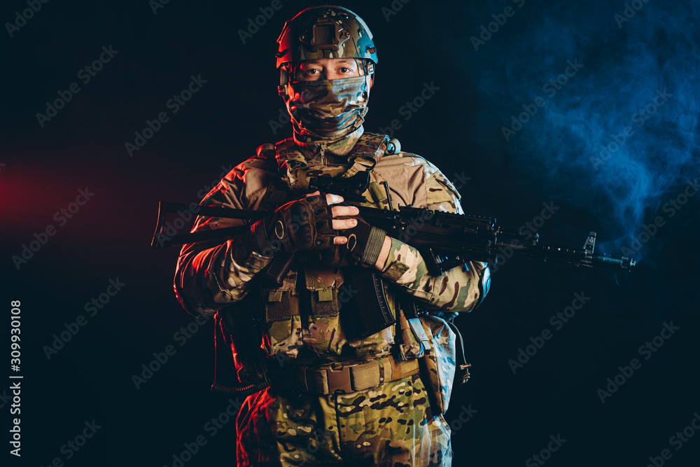 portrait of military man with gun isolated over smoky background ...