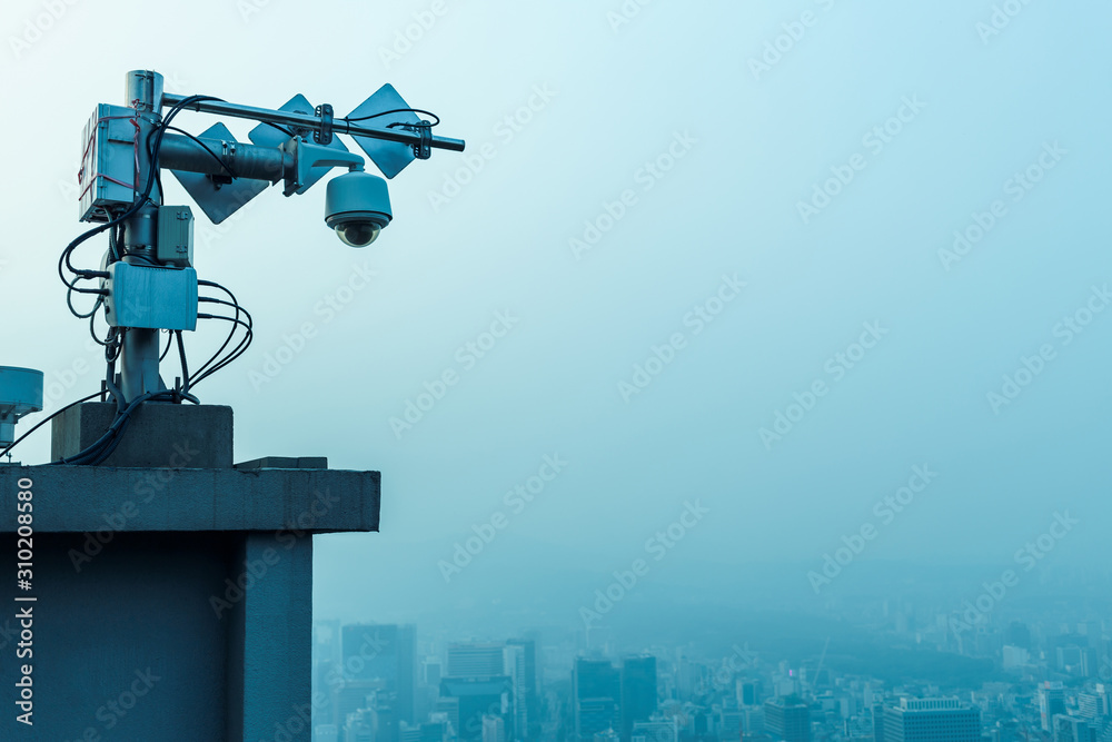outdoor CCTV security camera on high rise building rooftop in poor ...