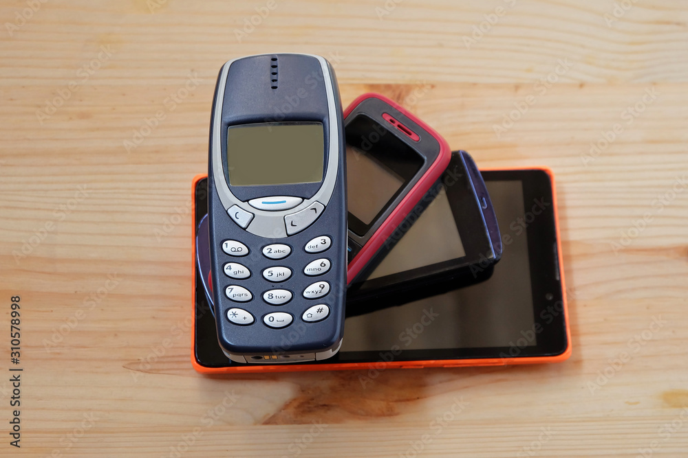 Old used mobile phones on wooden floors, E-waste is a problem with ...