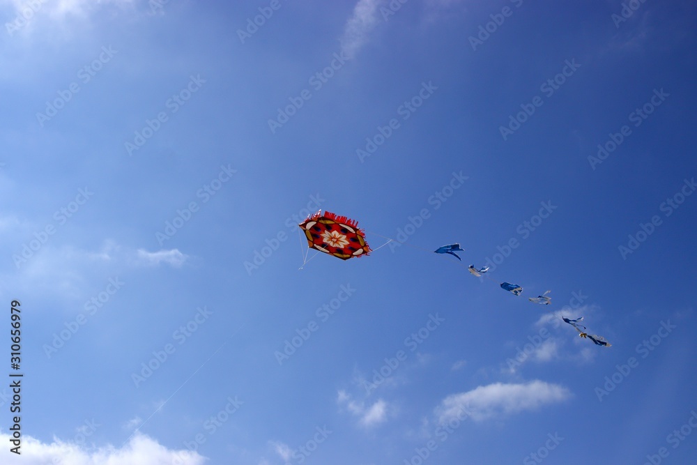 Paper kite flying alone into deep blue sky at the feast day of ...