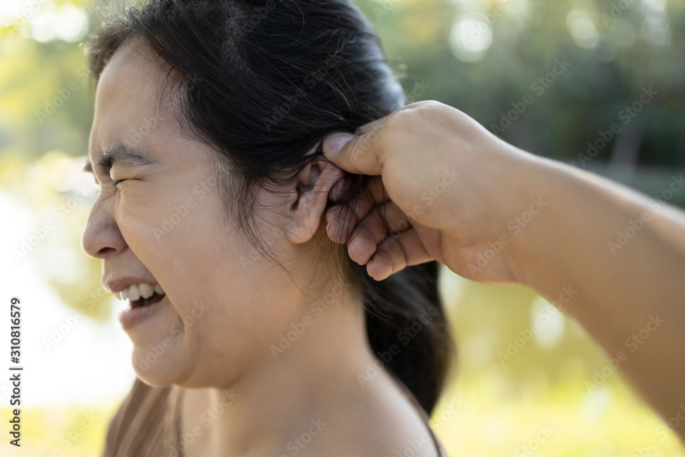 Disobedient asian woman being punished with ear pulling, angry husband ...