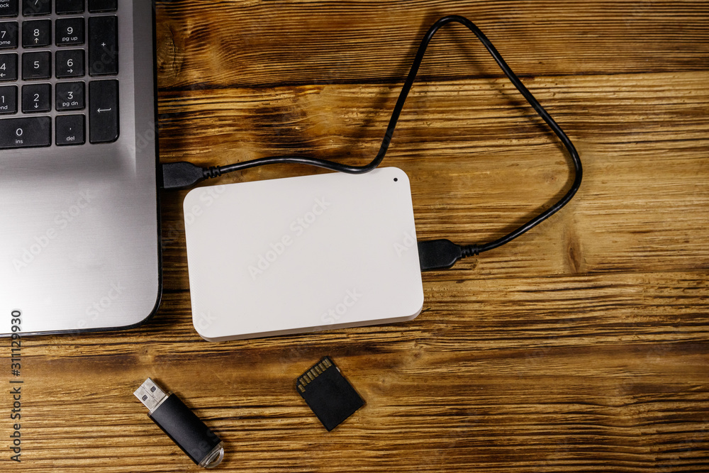 External HDD connected to laptop computer, SD memory card and USB flash ...