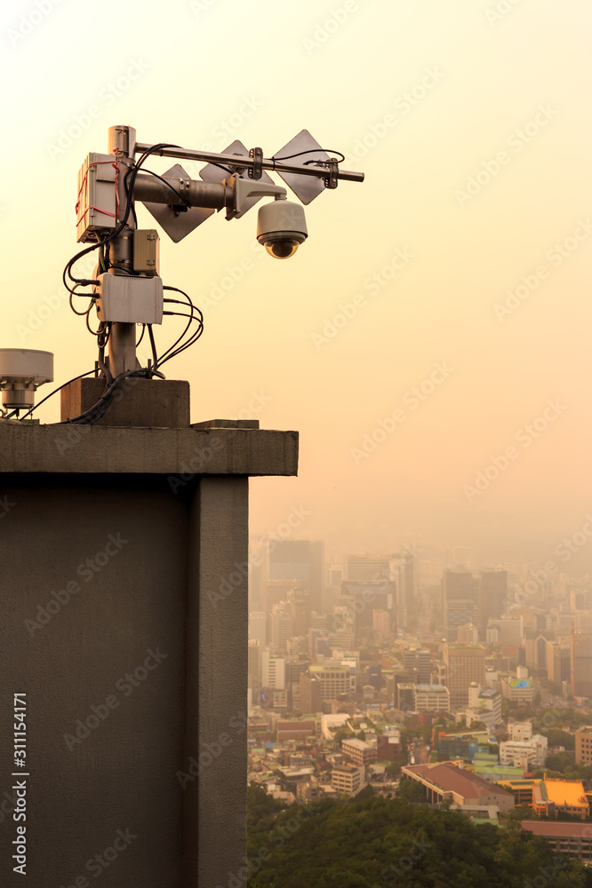 outdoor CCTV security camera on high rise building rooftop in poor ...