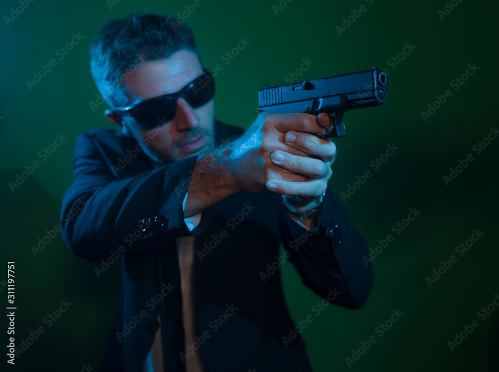 Man pointing handgun dramatic action portrait of attractive special ...