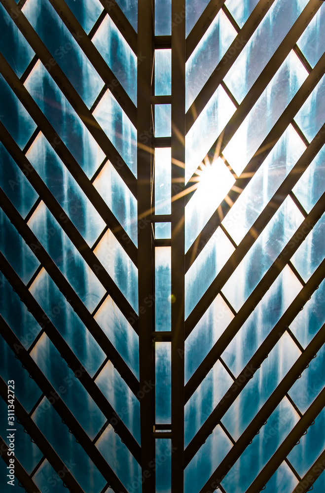 Reflection of sunsetting rays of light on modern steel and glass window ...