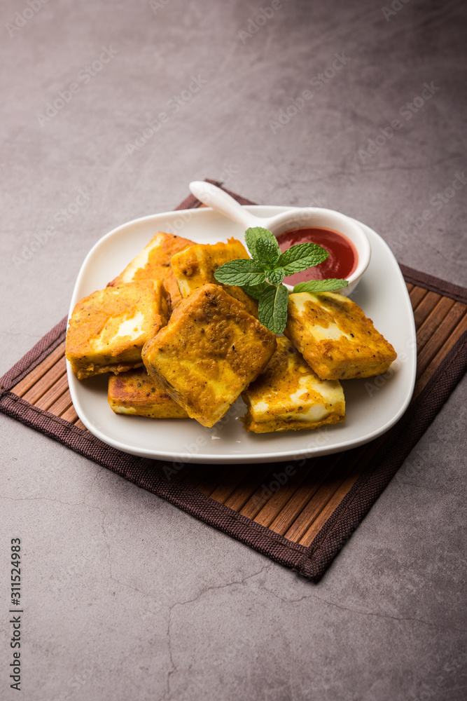 Amritsari Paneer Tikka made using cottage cheese cubes dipped in a ...