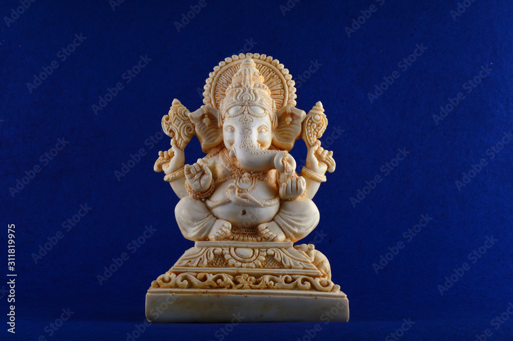Hindu God Ganesha. Ganesha Idol on blue background Stock Photo | Adobe ...