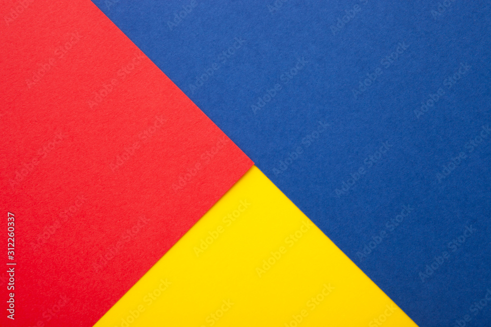 Red, blue and yellow paper texture as background with place for text ...