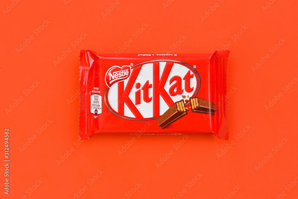 Kit Kat chocolate bar in red wrapping lies on red background. Kit kat ...