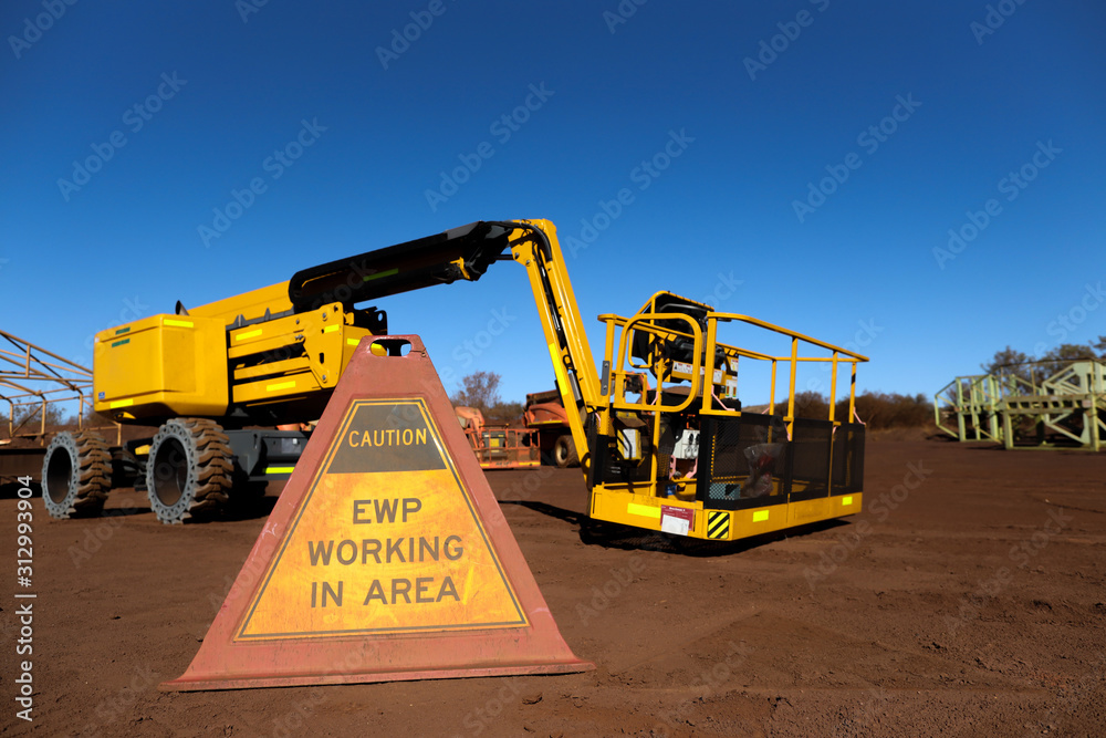 Elevated Work Platform caution warning triangle sign placing on the ...