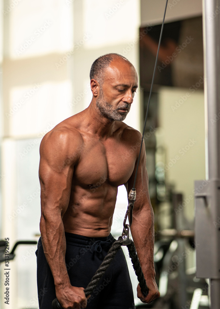 Muscular shirtless mature older bodybuilding athlete with balding gray ...