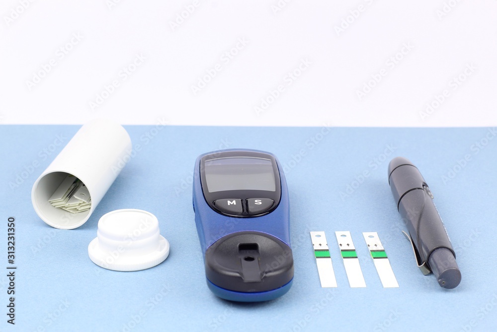 Glucometer. A device for measuring blood sugar levels. Test strips on a ...