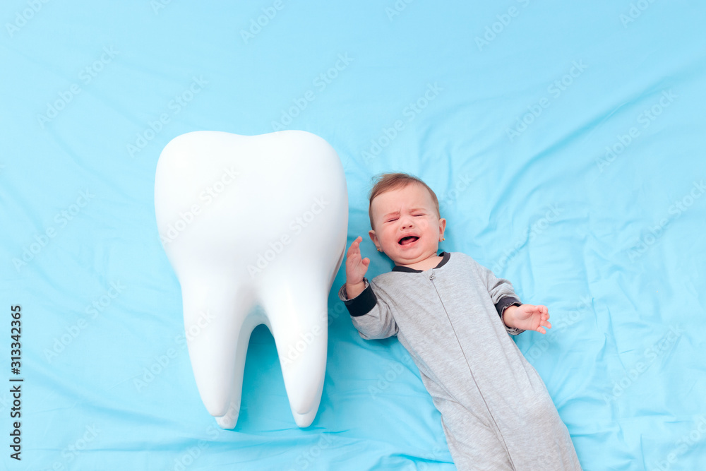 Crying Baby Girl Having Her First Milk Tooth Stock Photo | Adobe Stock