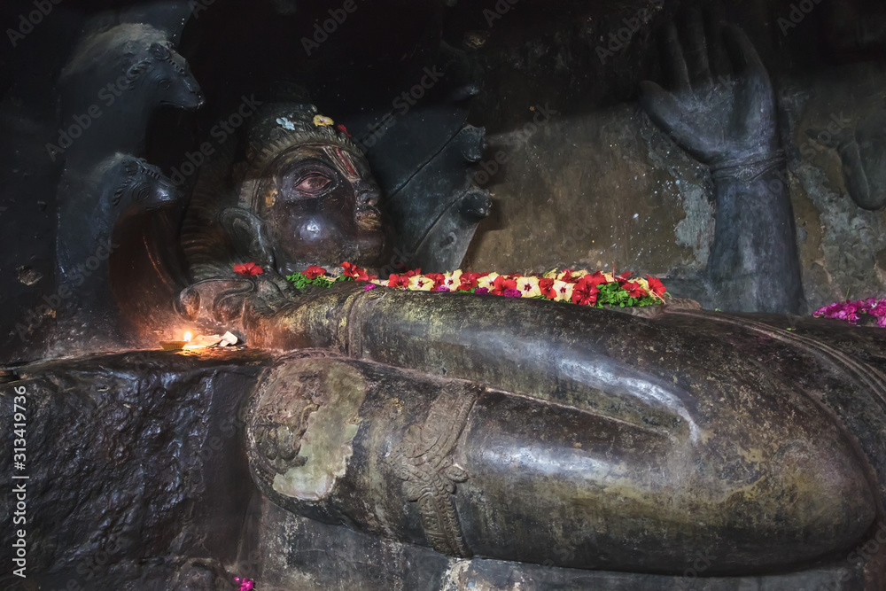 The ancient 7th century sculpture of the Hindu God Vishnu in reclining ...