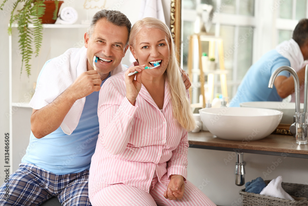 Mature couple brushing teeth at home Stock Photo | Adobe Stock