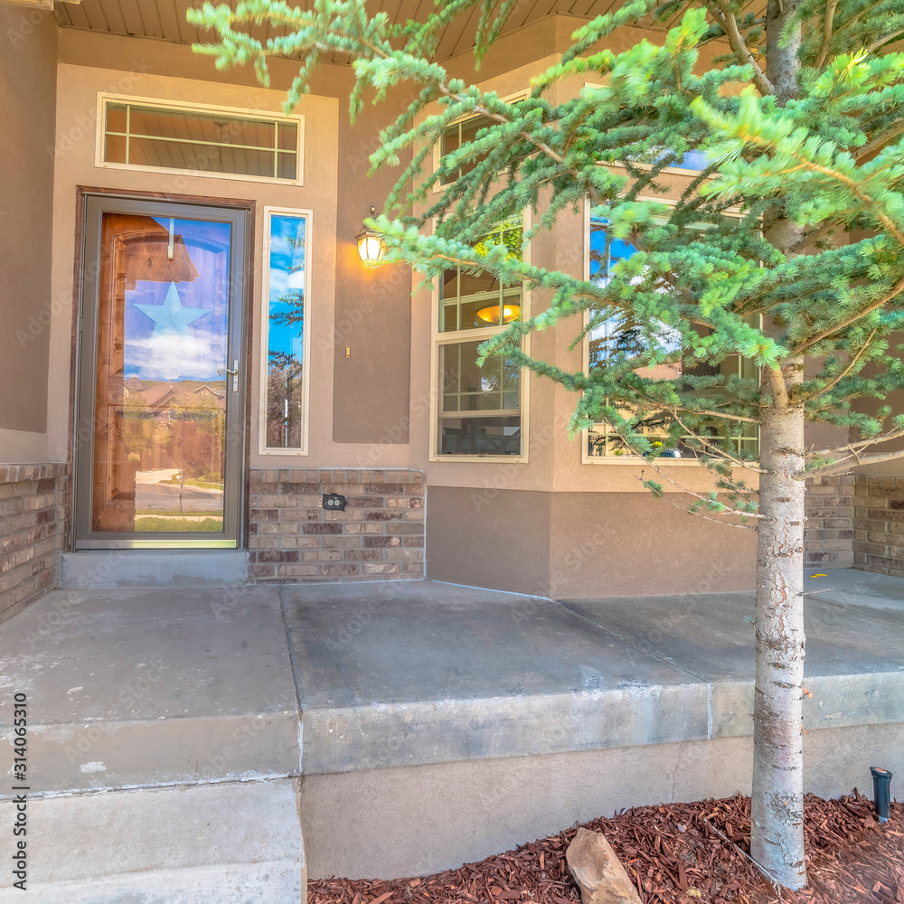 Square frame Home with bay window and glass paned door with sidelight ...