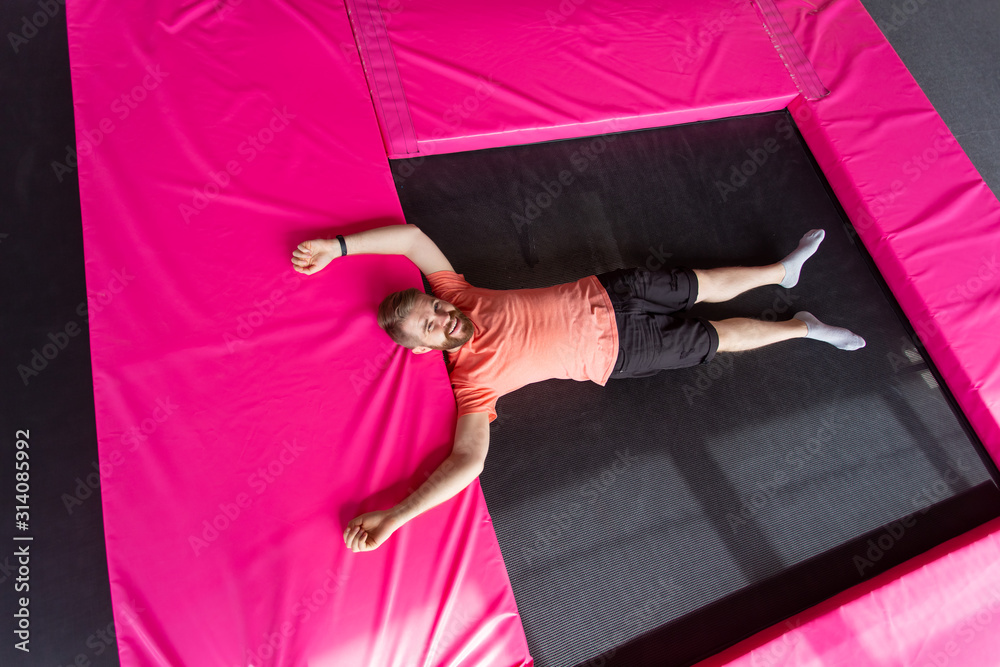 Fitness, fun, leisure and sport activity concept - Man lying on a ...