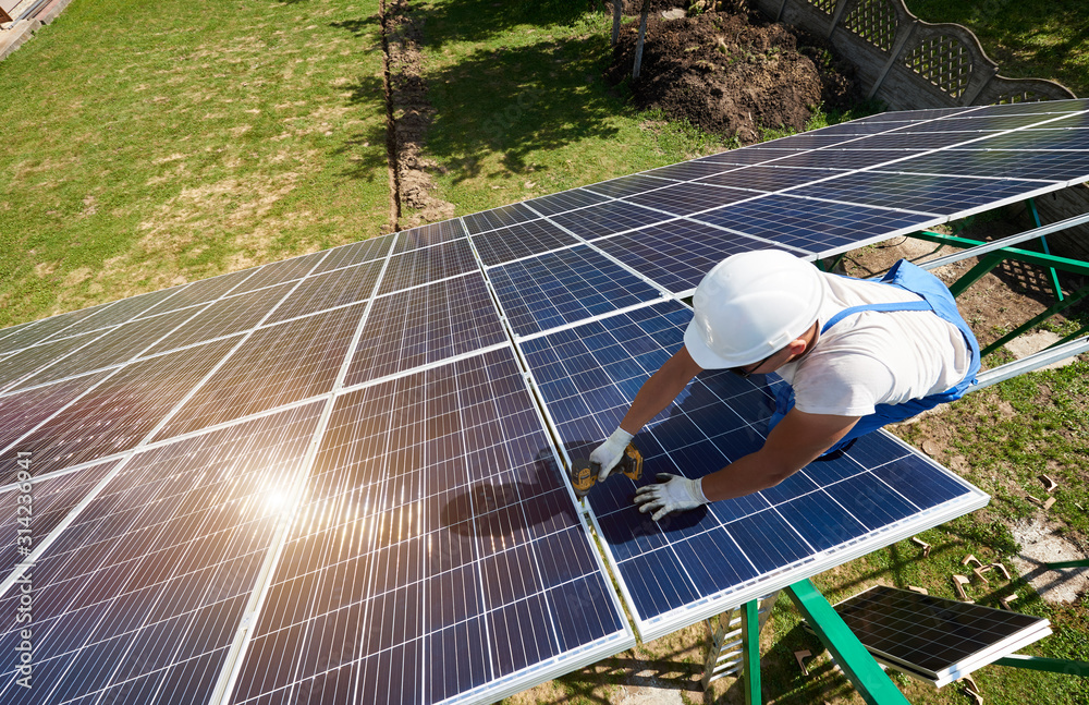 Concentrated mounter installing innovative solar batteries. Modern ...