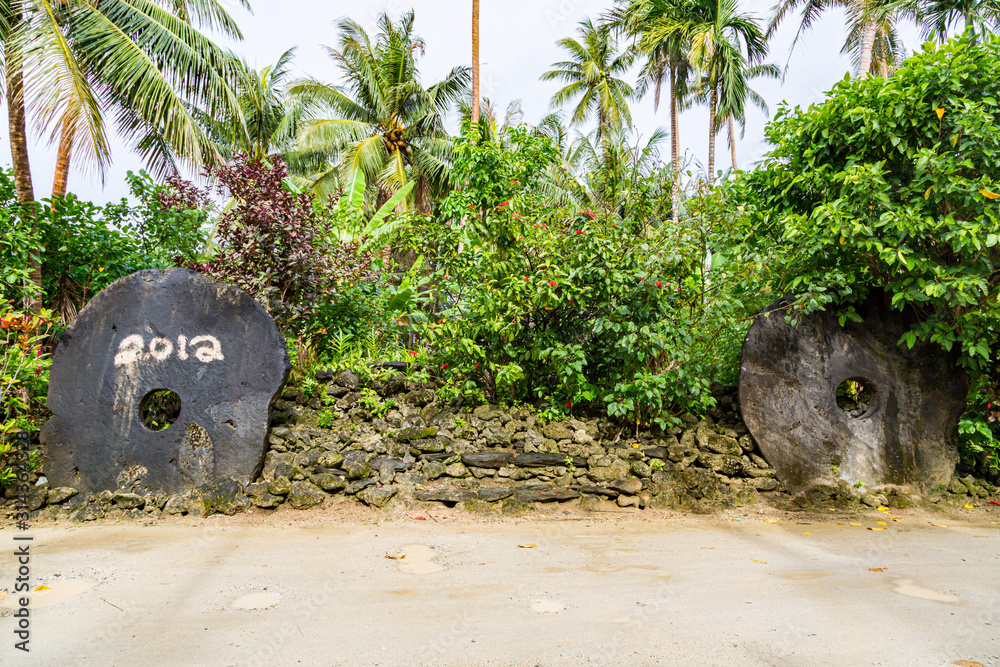 Two giant prehistoric megalithic stone coins or money rai, one signed ...