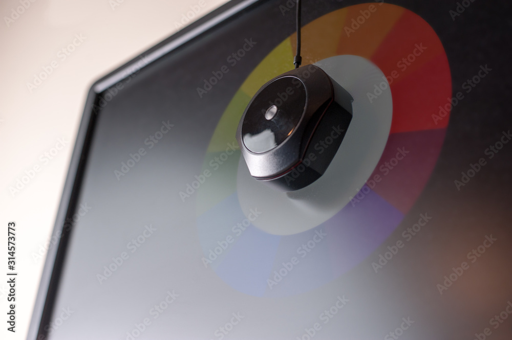 Colorimeter profiling computer monitor with color wheel image on ...