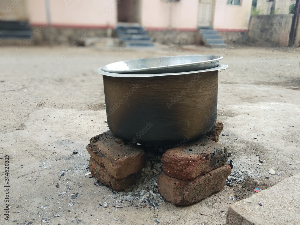 Photo Stock Traditional way of making food on open fire in old Indian ...