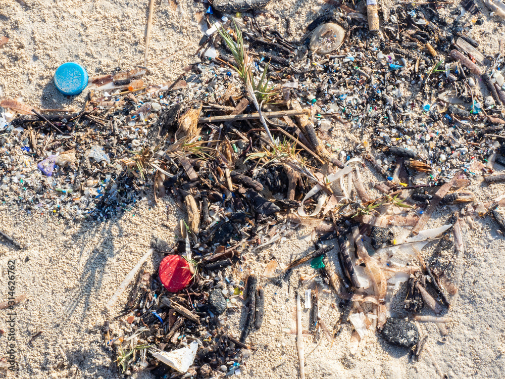 Environmental pollution. Sand beaches polluted with pieces of plastic ...