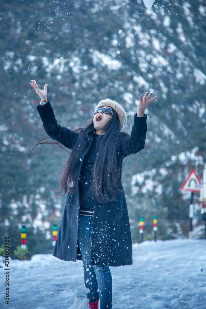 Photo Stock Happy Indian Woman enjoying her first snowfall during ...