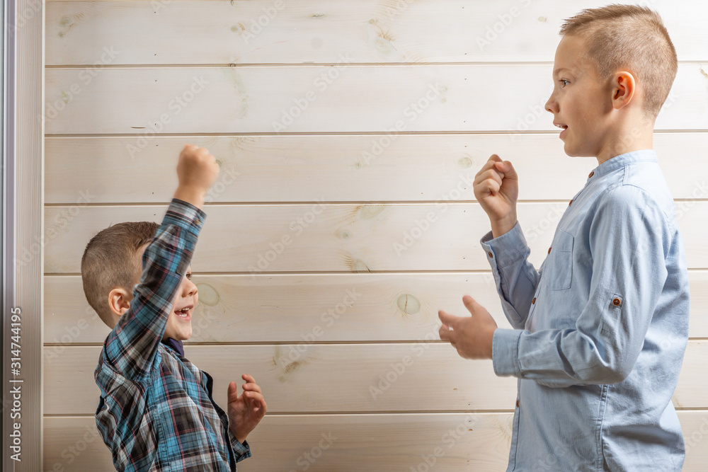 A 4-year-old boy in a blue klepy shirt cries on a light wooden ...