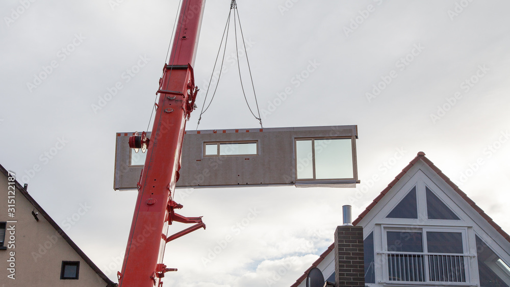 Completed component with a large window of a prefabricated house on a ...