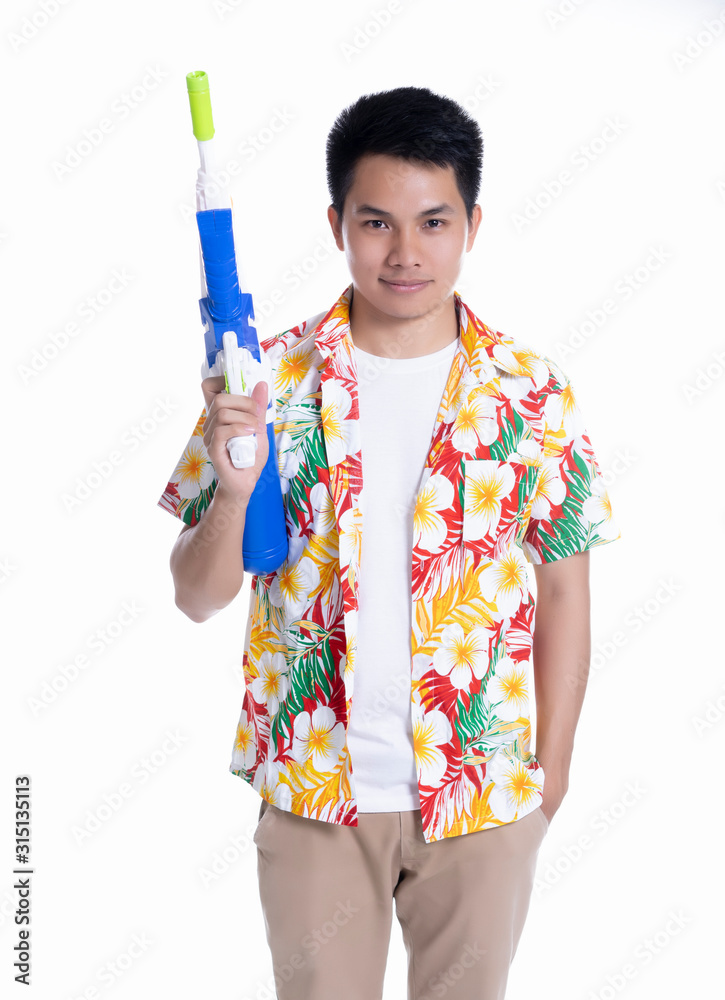 Smiling Asian Thai man holding plastic water gun at Songkran festival ...