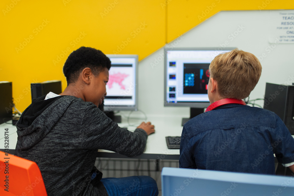 Junior high boy students using computers in computer lab Stock Photo ...