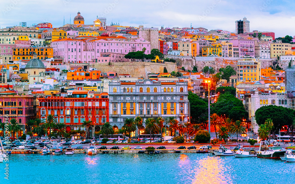 Old Sardinian Port with ships at Mediterranean Sea and city of Cagliari ...