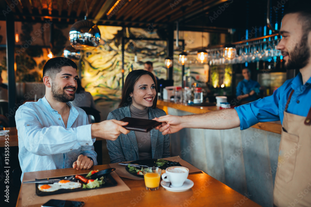 man paying bill with cash in restaurant Stock Photo | Adobe Stock