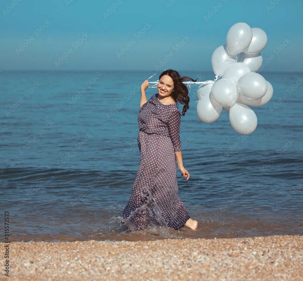 Plus size model posing with white balloons. Stock Photo | Adobe Stock