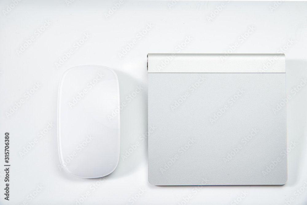 White computer mouse and silver trackpad. The concept of comparing ...