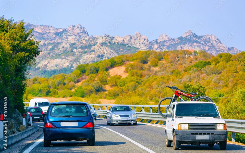 Camper with bicycles on road at at Mediterranean Sea in Sardinia Island ...