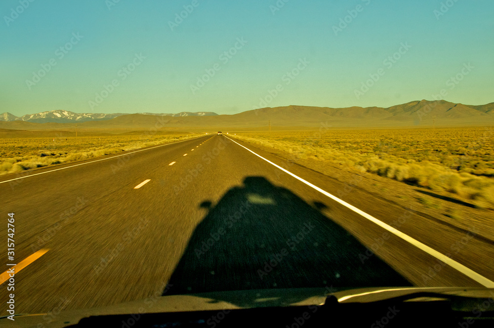 Road Trip, driving east on highway 50 with strange shadow of car ...
