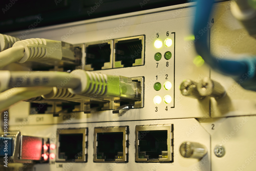 Front panel of an old internet switch. Network interfaces and cables ...