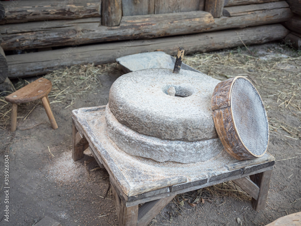 Stockfoto Rotary discoid mill stone for hand-grinding a grain into ...