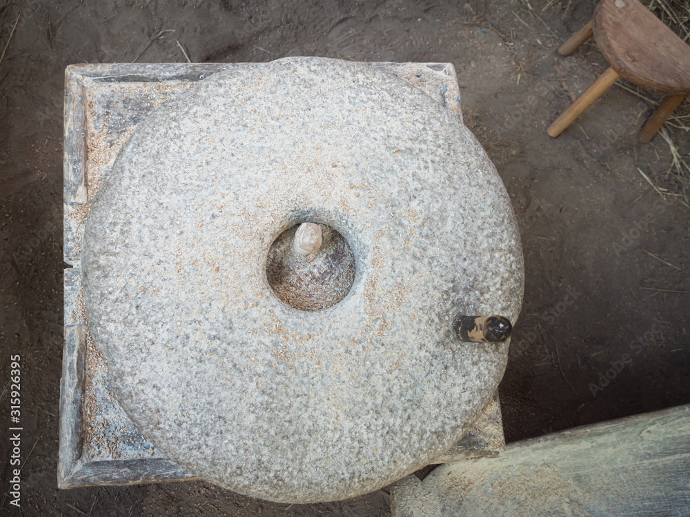 Rotary discoid mill stone for hand-grinding a grain into flour ...