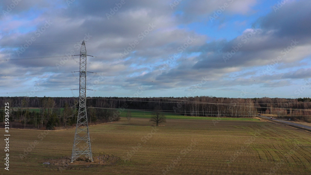 Tower of power lines in the forest. Electric tower line in Landscape ...