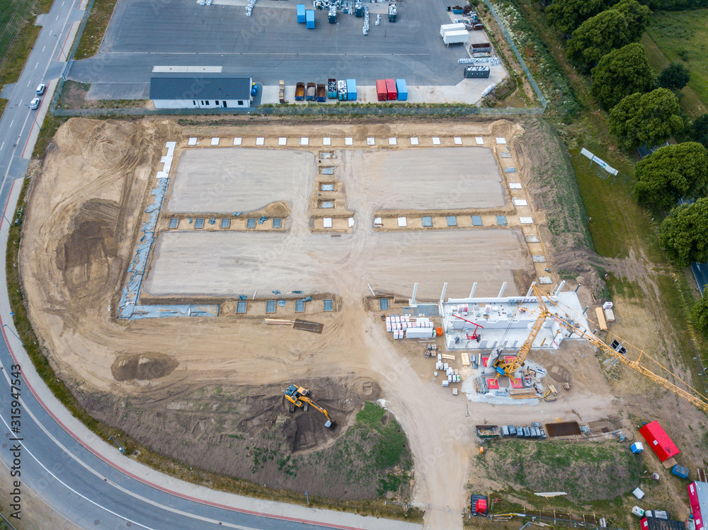 Drone photos of a large construction site on which a factory building ...