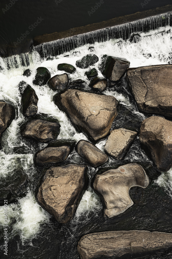 Water crashing around rocks in the river below the Alexandra Suspension ...
