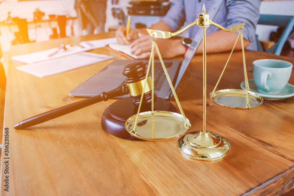 Brass scales are placed on the tables within the lawyer's office for ...