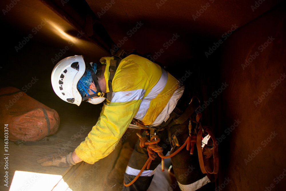 Foto de Stock Construction site worker wearing safety white hard hat ...