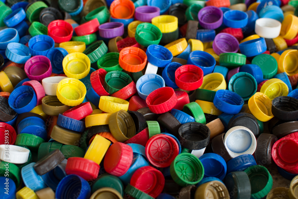 Plastic bottle caps background. Cap material is recyclable.Remove lids ...