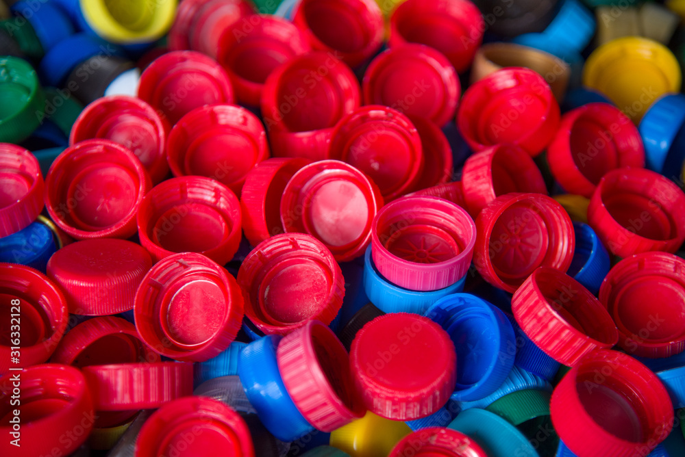 background. Cap material is recyclable.Remove lids from plastic bottles ...