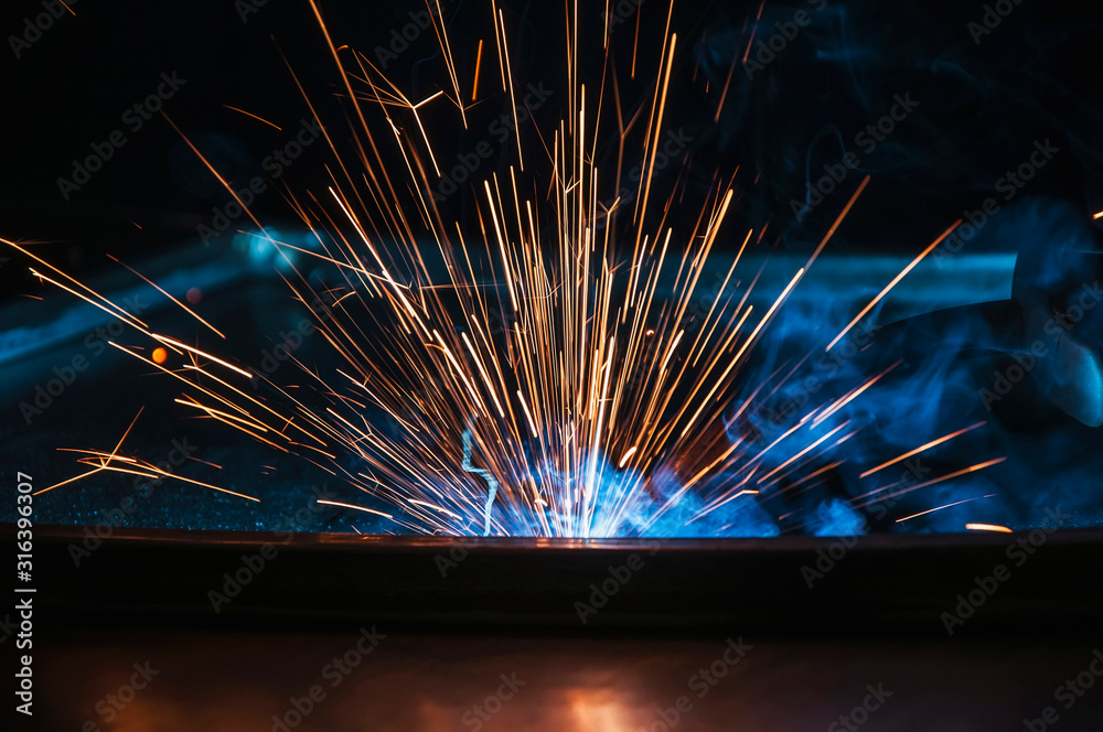 Industrial welding of iron construction. Process by manual welding ...