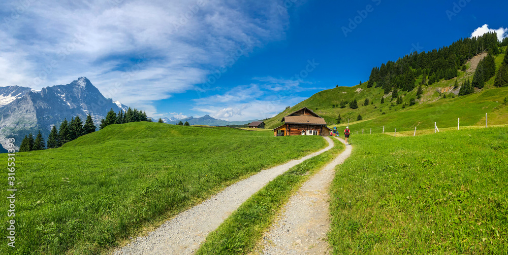 Magnificent panoramic view of the swiss alps, single cottage house at ...