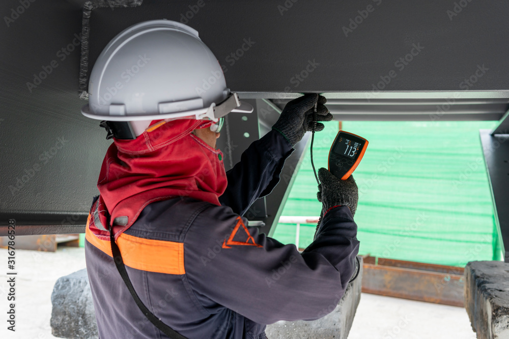 Technicians are measuring the Dry Film Thickness (DFT) with Coating ...